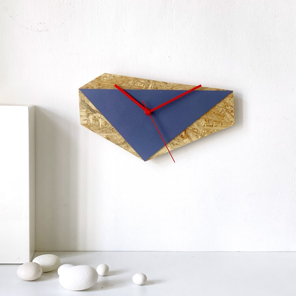 Blue triangle wall clock with red hands • Jagged Squares